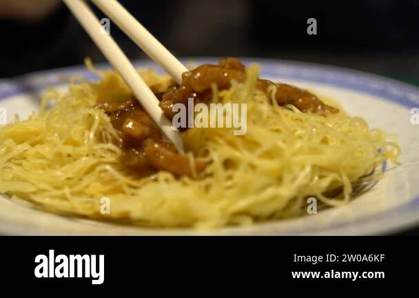 Slow motion people eating a famous noodles with meat for lunch in an ...
