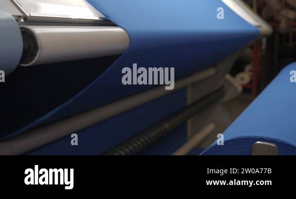 The garment factory takes a sample of a roll of blue fabric checking ...