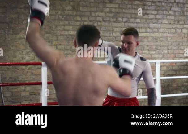Muay Thai Boxer Performing Jumping Air Kicks with Knee on Punch Pad in ...