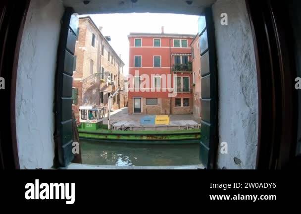4K View through an open window inside a house of boat collecting ...