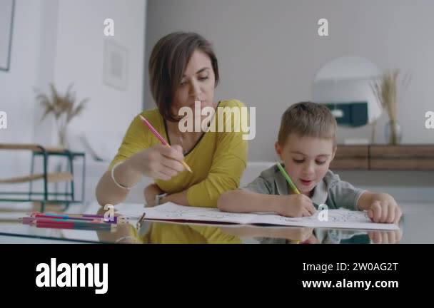 Beautiful young mother in a warm sweater lying on the floor with my son ...