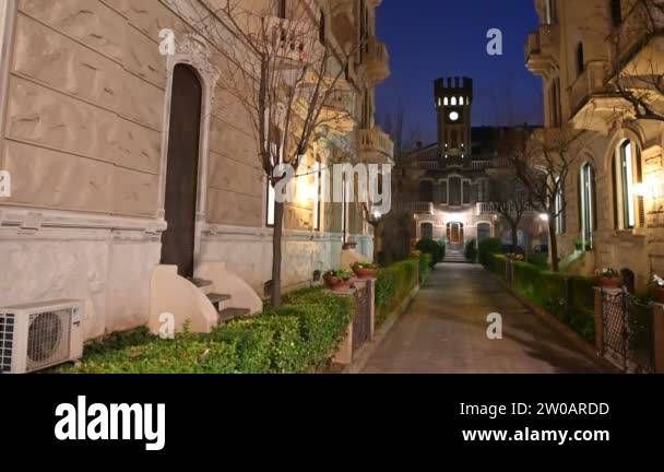 Night footage of the driveway with hedges of a courtyard from the early ...