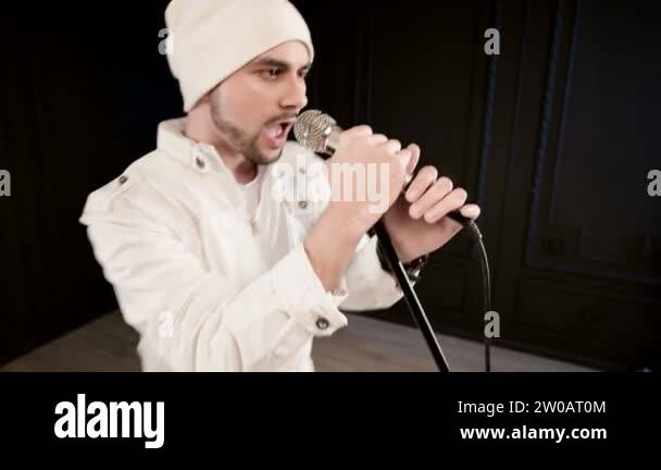 Frontman vocalist rock pop with a stylish beard in white clothes and a ...