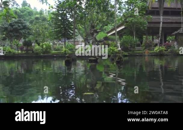 Indonesia god statue in water pond at Bali temple, Indonesia ...
