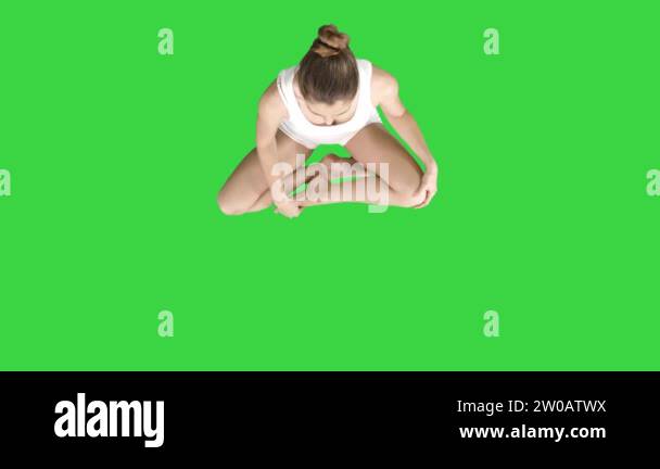 Young woman meditating in Lotus Pose on a Green Screen, Chroma Key ...