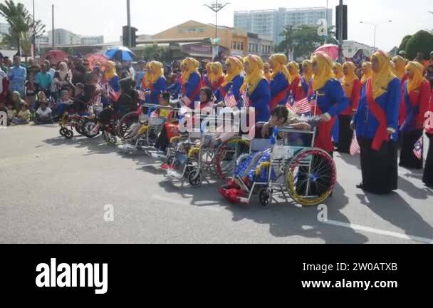 Handicapped kids sit at wheelchair being push to join the Merdeka ...