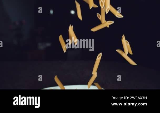 SUPER SLOW MOTION CLOSE UP DOF: Uncooked penne flying through the air ...