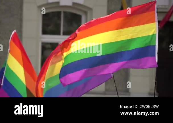 Rainbow flag supporting LGBT community on gay parade event. Colourful ...