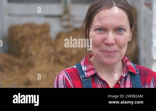 Smiling female farmer posing on farm. Confident woman farm worker ...