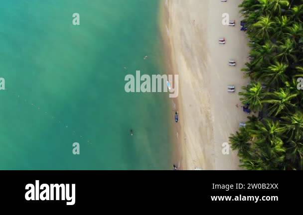 Blue lagoon and sandy beach with palms. Aerial view of blue lagoon and ...