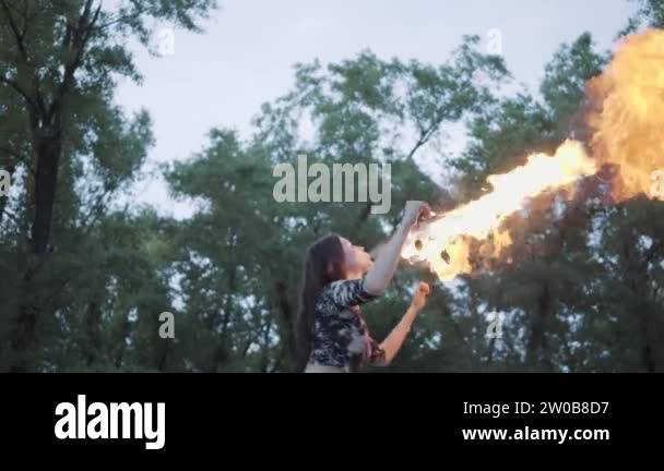 Portrait cute confident woman performing a show with flame standing in ...