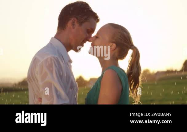 SLOW MOTION, CLOSE UP, LENS FLARE: Young Caucasian couple kisses in the ...