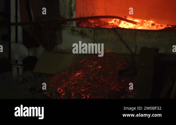 The process of melting metal at the plant in the furnace. Workers ...