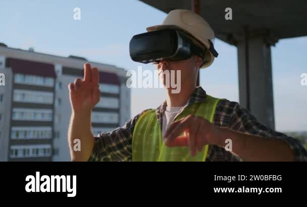 Engineer the Builder on the roof of the building stands in VR glasses ...