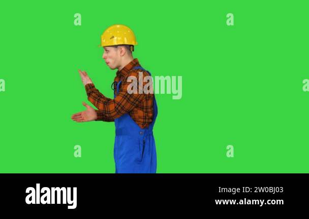 Funny construction worker making a flip and loses safety hat on a Green ...