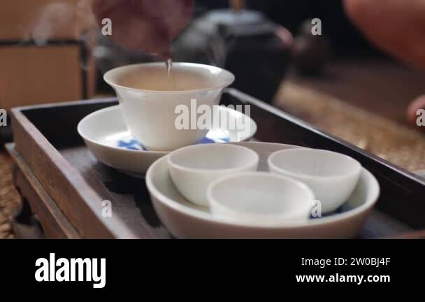 Traditional Chinese gongfu or kung fu tea ceremony. Tea master pours ...