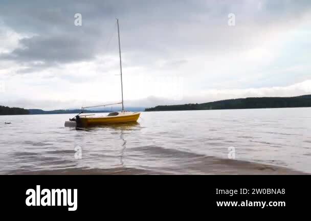 Sailing ship, sailboat, small sailing boat under spoiled sails and ...