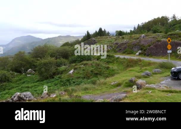 Panning shot showing small car park by the popular Ring of Kerry road ...