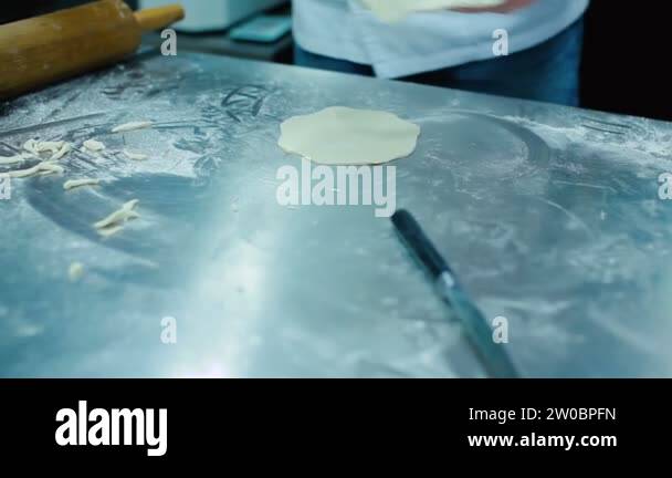 Cook put the pan on the table. Baking tray covered with parchment paper ...