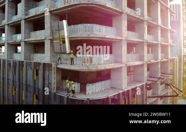 Workers are Installing the Precast Glass Panel on The Construction Site ...