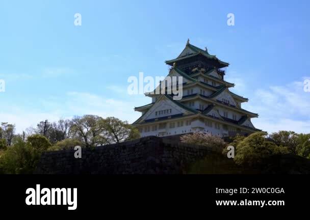 4K, Main tower of Osaka Japanese Castle behind rock wall, famous ...