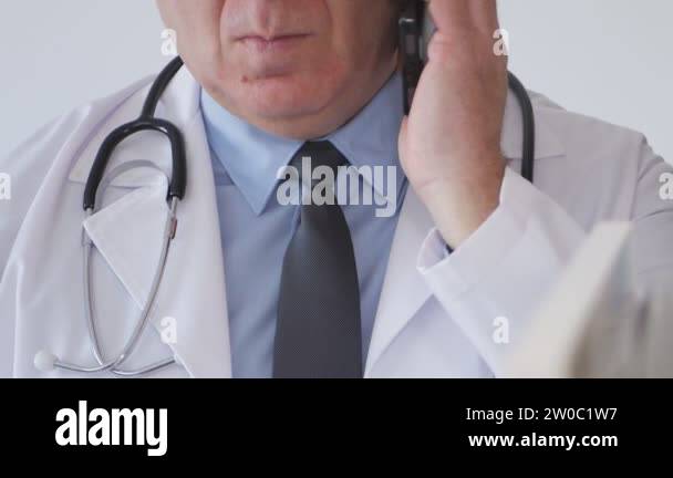 Pan View with a Doctor Talking to Mobile and Making No Hand Gestures ...