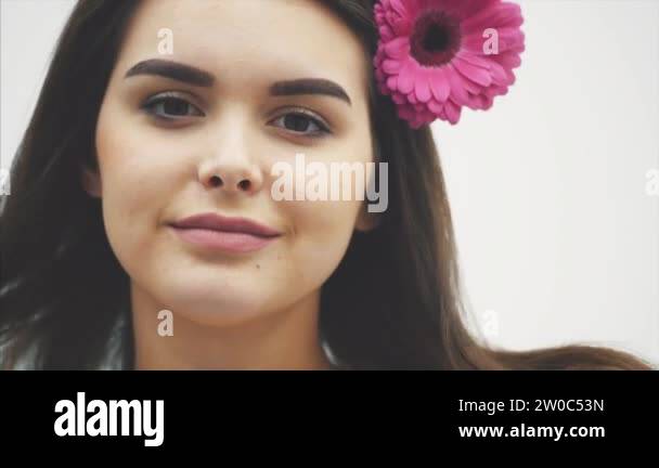 Young attractive spa model woman with pink flower, isolated on white ...