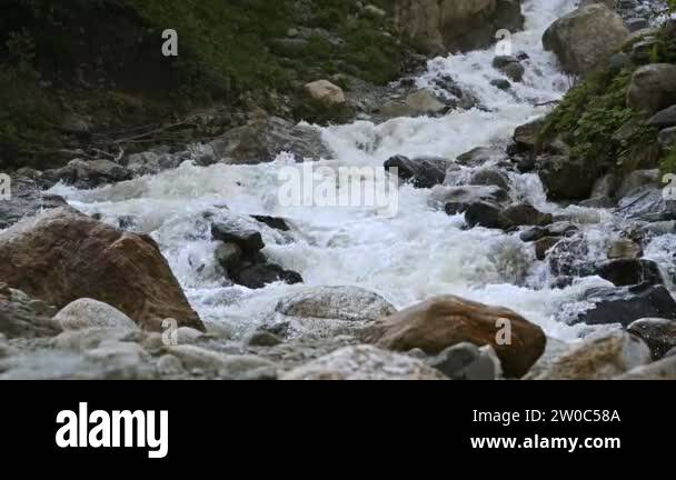 Slow motion water falls from a huge rock. Waterfall in the natural ...