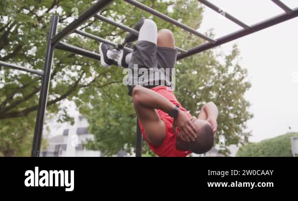 Side view of a disabled mixed race man with a prosthetic leg, working ...