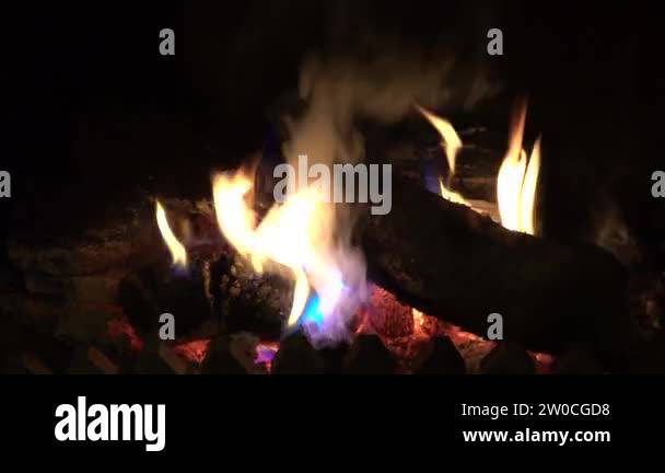 wood burning on open fire place with blue flame, because of chemical ...