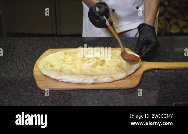 Close-up of chef prepares delicious Italian pizza in restaurant. Frame ...
