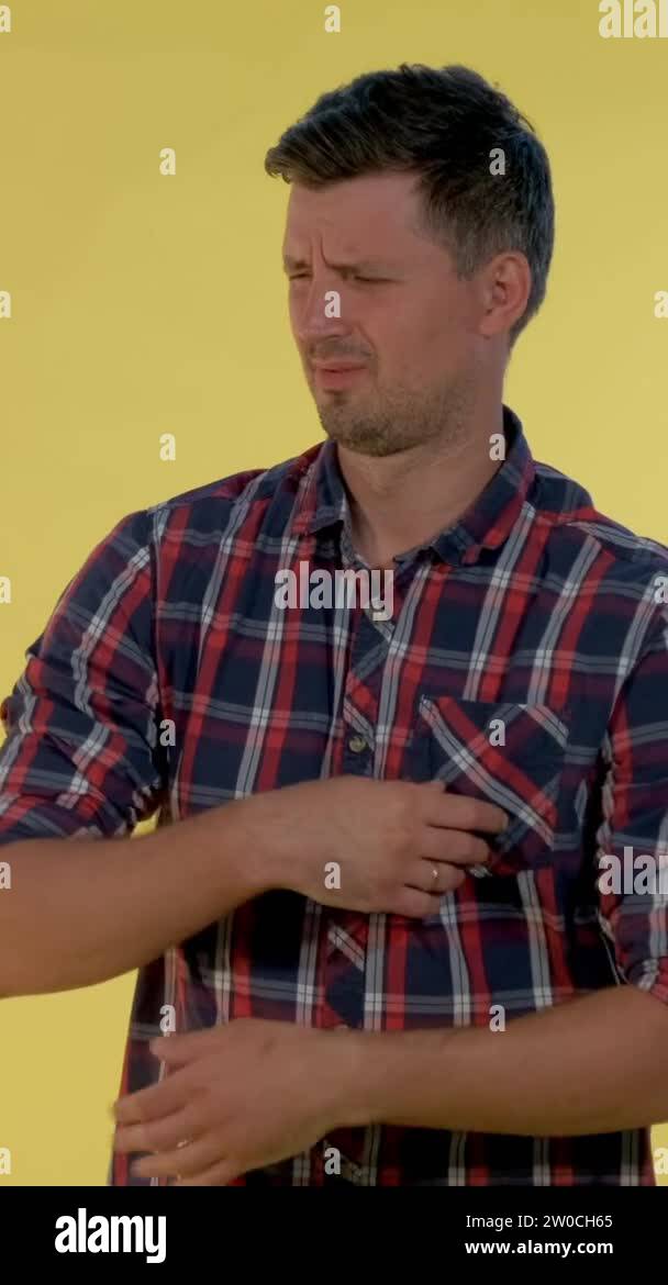 Handsome young man disliking something and giving thumbs down Stock ...