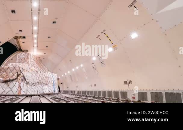 Loading air cargo freighter inside aircraft - Panning time lapse Stock ...