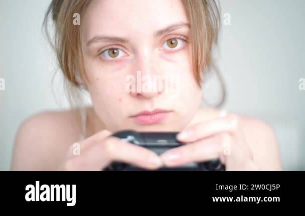Game addiction. A female gamers face with a game dependency close-up ...