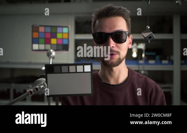 Video balanced by ColorChecker. Man testing professional film camera ...