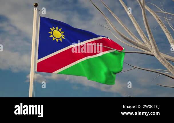 Namibia flying flag waving in blue sky. National Namibian independence ...