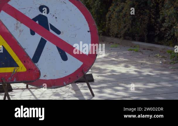 Man in black pants and shoes walk past by the prohibition sign. The ...