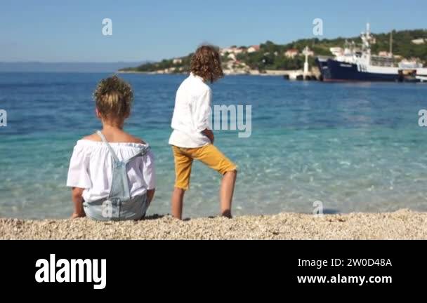 Rear view, schoolchildren curly boy and girl playing with each other on ...