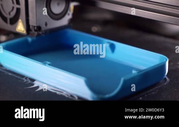 3D printer working. Fused deposition modeling, 3D printer printing an object from plastic ...