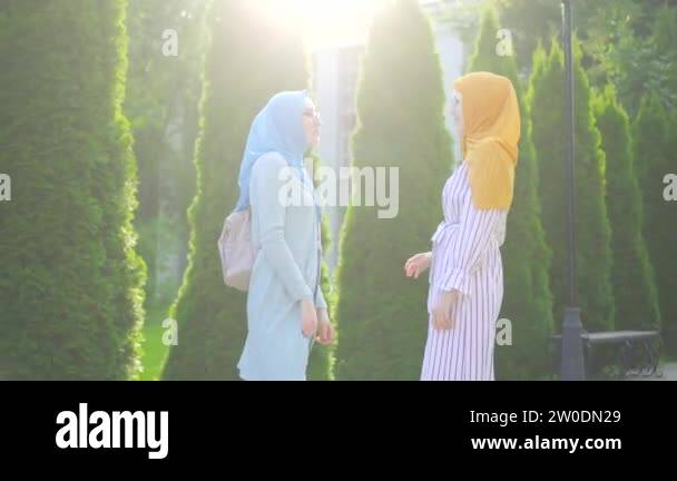 Two young hard of hearing muslim women in traditional scarves and ...