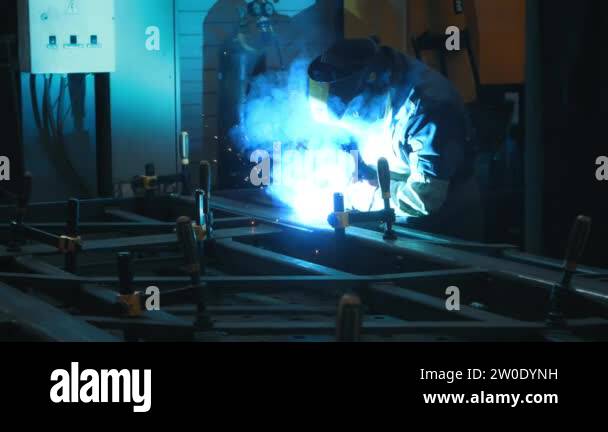 Metal welding process in dark industrial room. Metal steel structure in ...