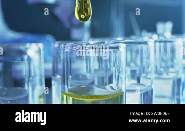 Pharmaceutics Laboratory: Pipette Dropping Yellow Liquid into Test ...