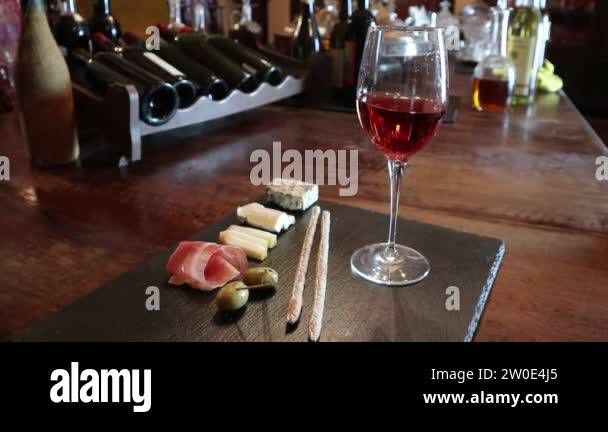 Wine test, crystal glass, red wine, cheese, bar counter background ...