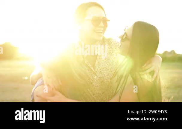 Beautiful young woman giving teenage girl friend kiss on cheek hugging ...