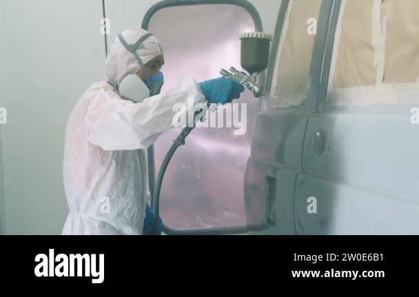 Industrial spray painting process. Paint-spraying gun is getting used ...