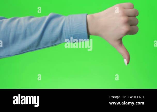 Thumbs down sign hand gesture on green screen. Simbol of disapproval ...