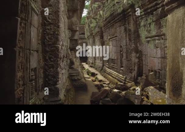 POV: Walking down narrow path between two beautiful decaying Buddhist ...