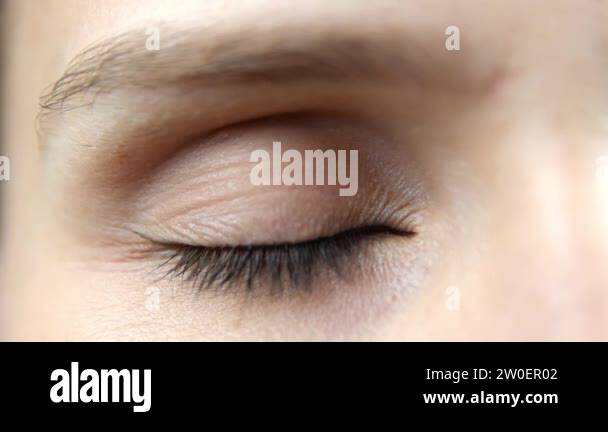 Extreme close up of opening beautiful sad blue woman eye and looking ...