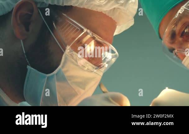 Baldness treatment. Hair transplant. Surgeons in the operating room ...