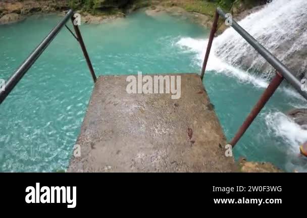 Slow motion walking to edge of jumping platform and looking down at the ...